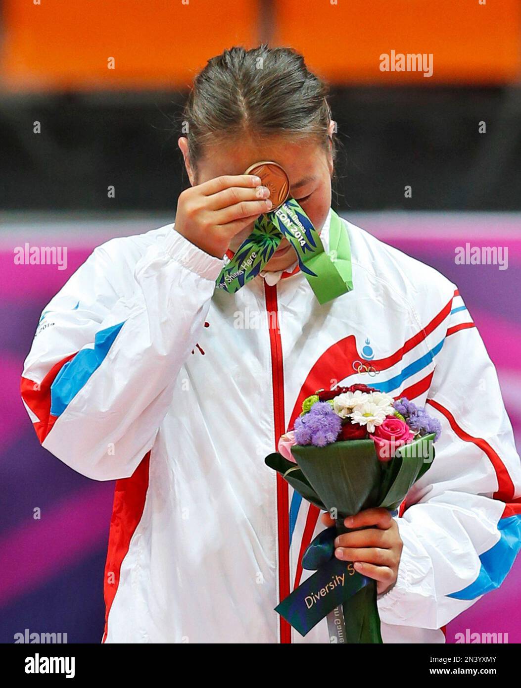 Mongolia’s Tserenchimed Sukhee touches her bronze medal to her forehead ...