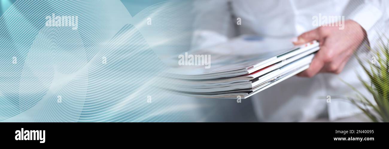 Female hands holding a stack of magazines; panoramic banner Stock Photo ...