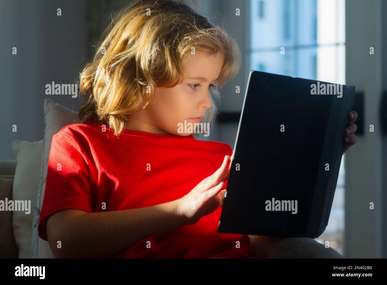 Smart, clever child. Intelligent kid boy read book. Young teenager boy ...