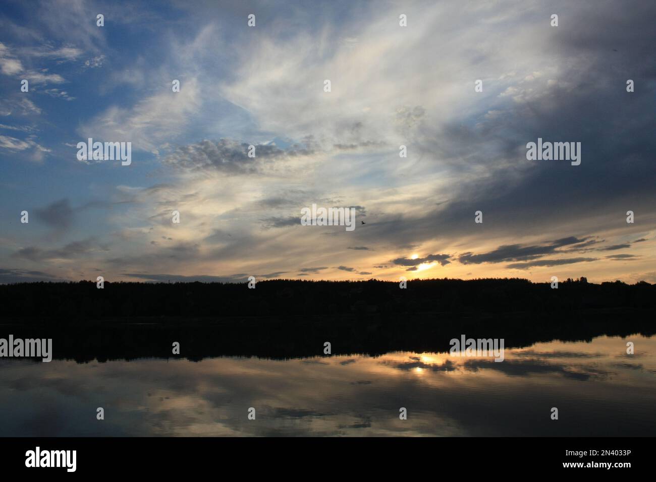 Waterside forest silhouette and sunset landscape photo Stock Photo - Alamy