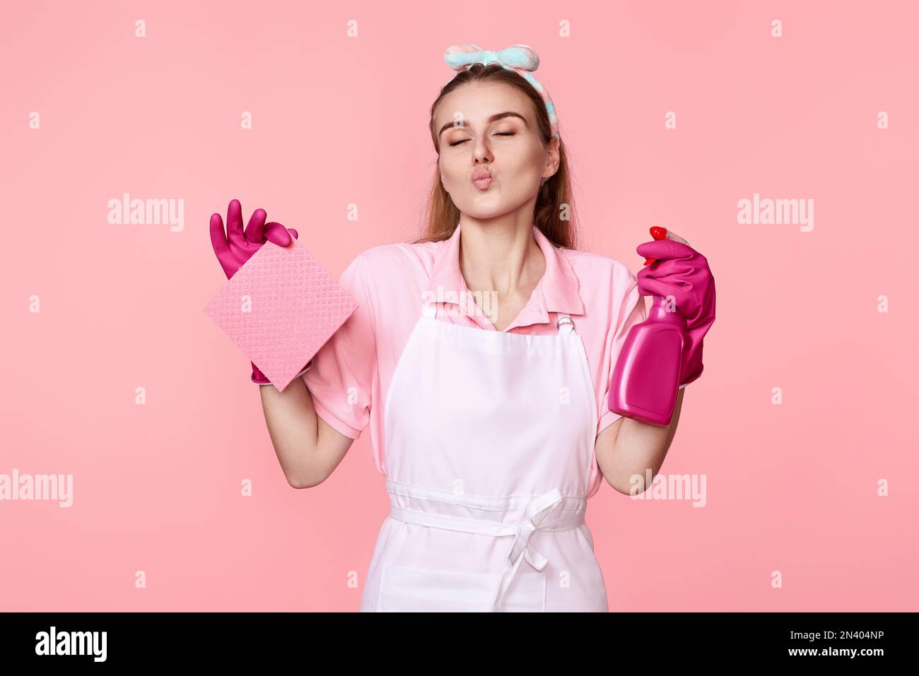 caucasian woman in gloves and cleaner apron with sponge and detergent ...