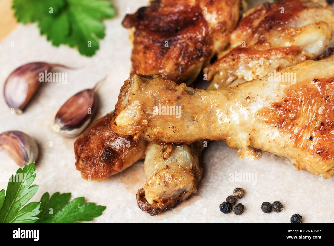 Roasted chicken legs with spices and herbs on a light background ...