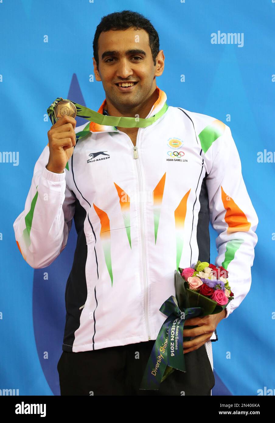 India's Sandeep Sejwal holds up his bronze medal in the men's 50-meter ...