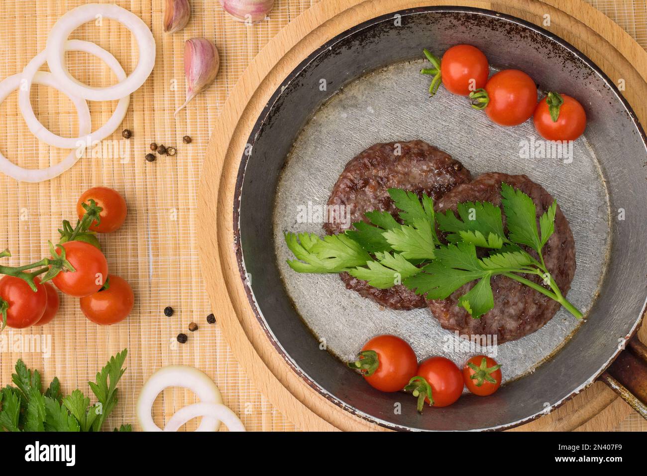 Fried Ground beef meat Burger steak cutlets in a cast iron pan on a ...