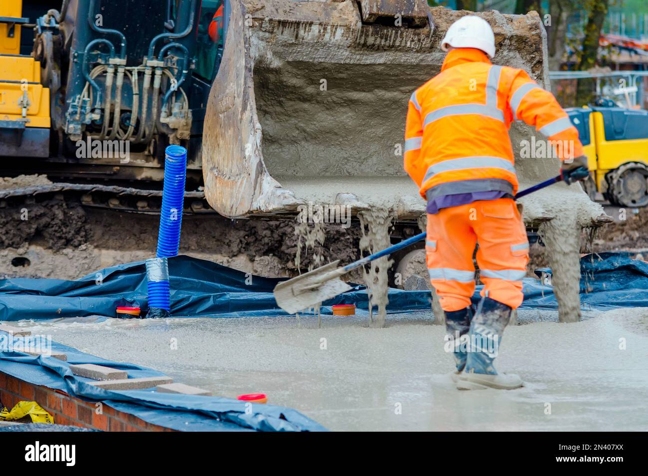Builder pouring ground floor slab of a new house with wet ready-mix ...