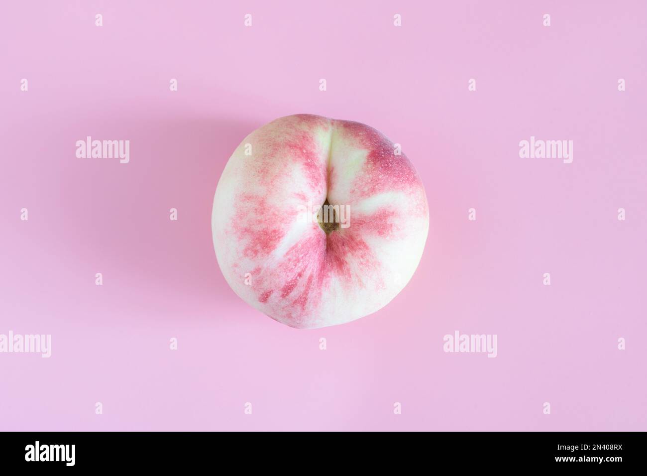 flat peach isolated on pink background. one figs, the peach, is located ...