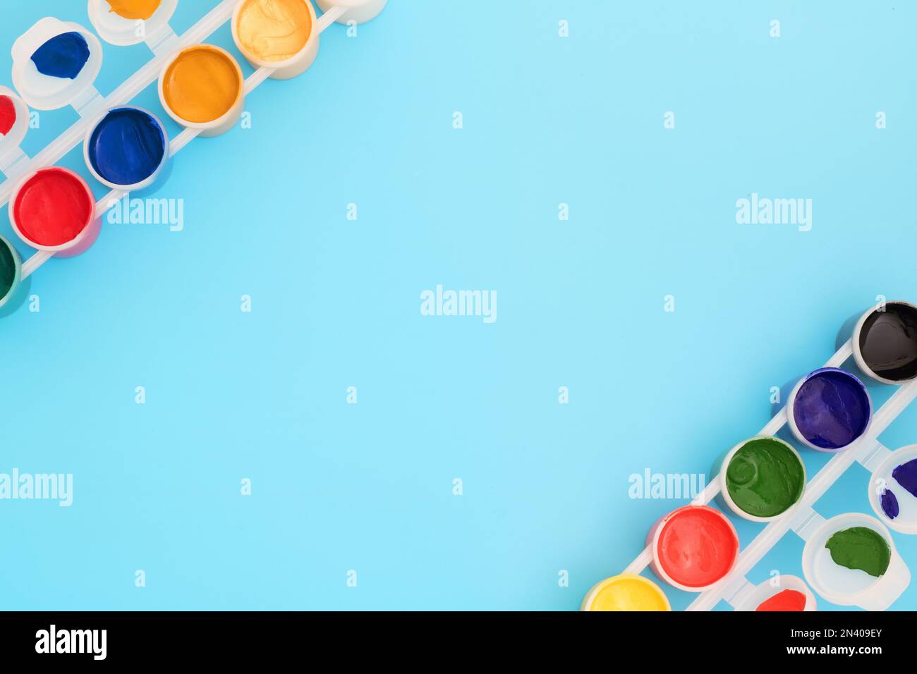 Multi-colored paint in cans on blue background. Palette of colors ...