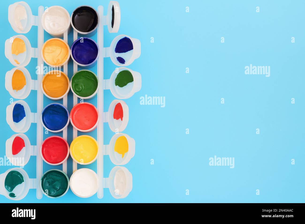 Multi-colored paint in cans on blue background. Palette of colors ...
