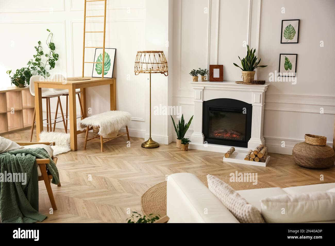 Elegant artificial fireplace and logs in room. Interior design Stock ...