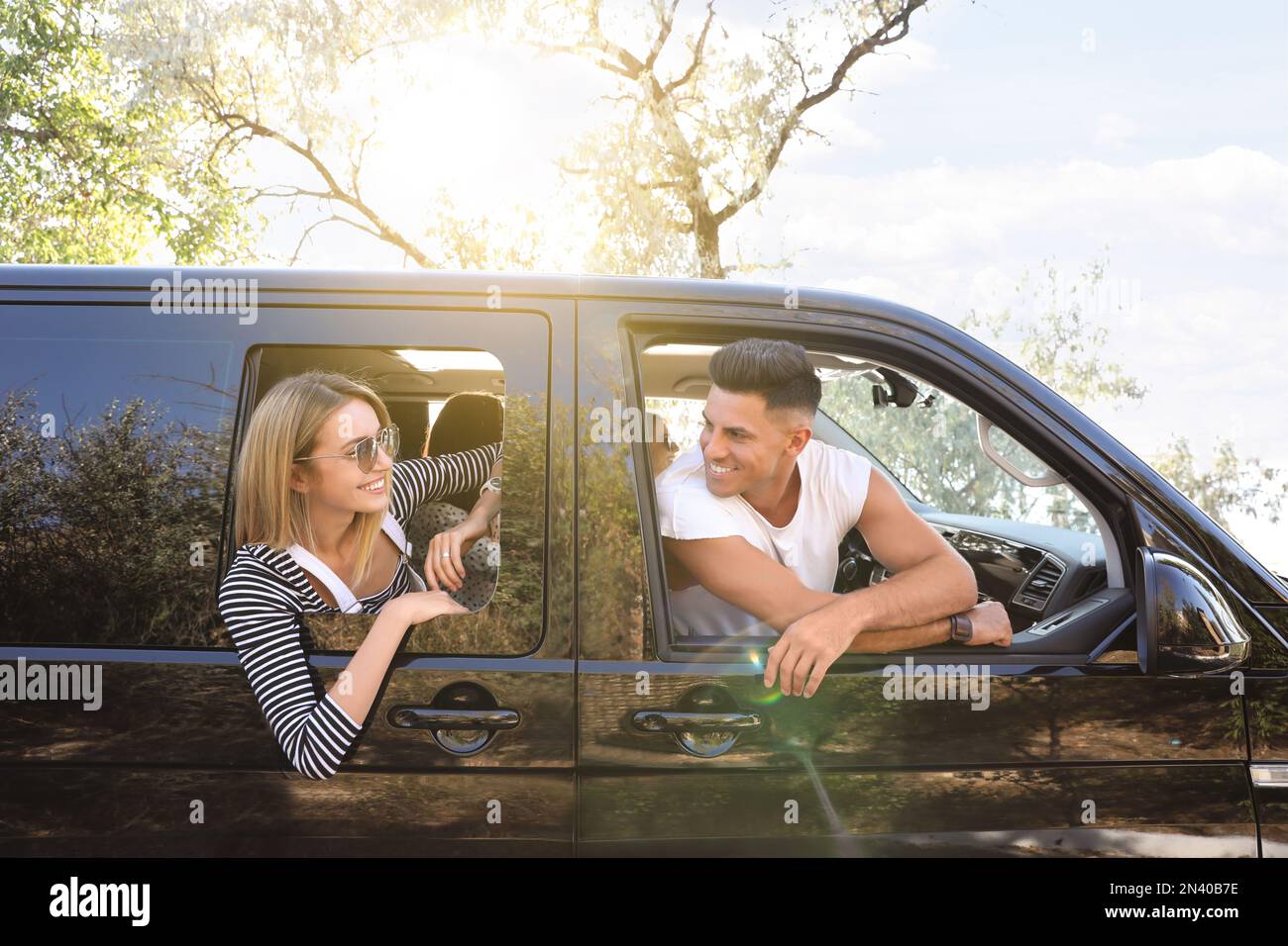 Happy friends together in car on road trip Stock Photo - Alamy