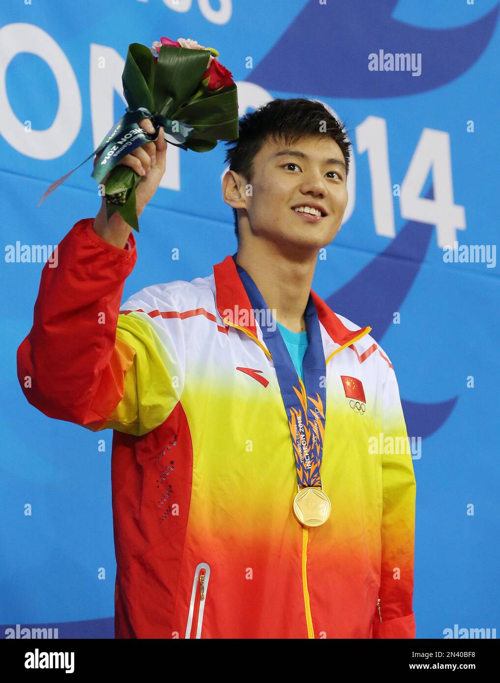China's Ning Zetao waves from the podium after winning the men's 100 ...