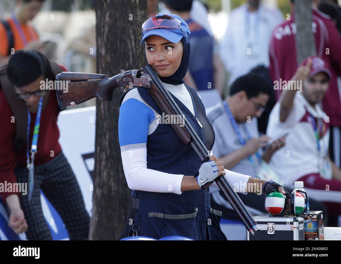 Shooting athlete Afrah Mohammad of Kuwait carries her shotgun before a practice at the 17th ...
