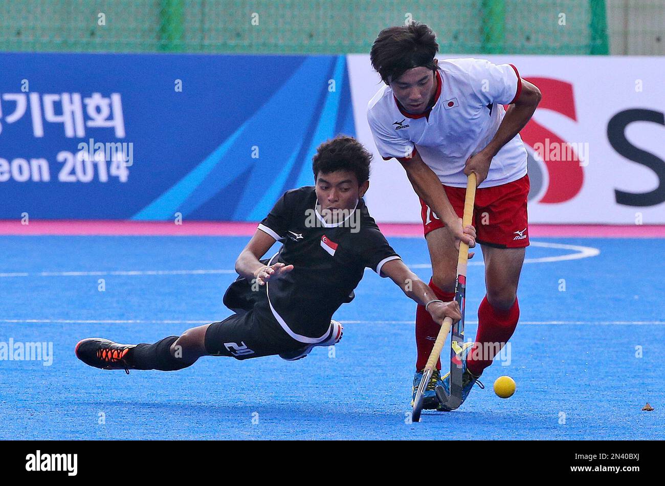 Japan's Yasuhiro Nakayama right, and Singapore's Ahmad Faris Muhammad ...