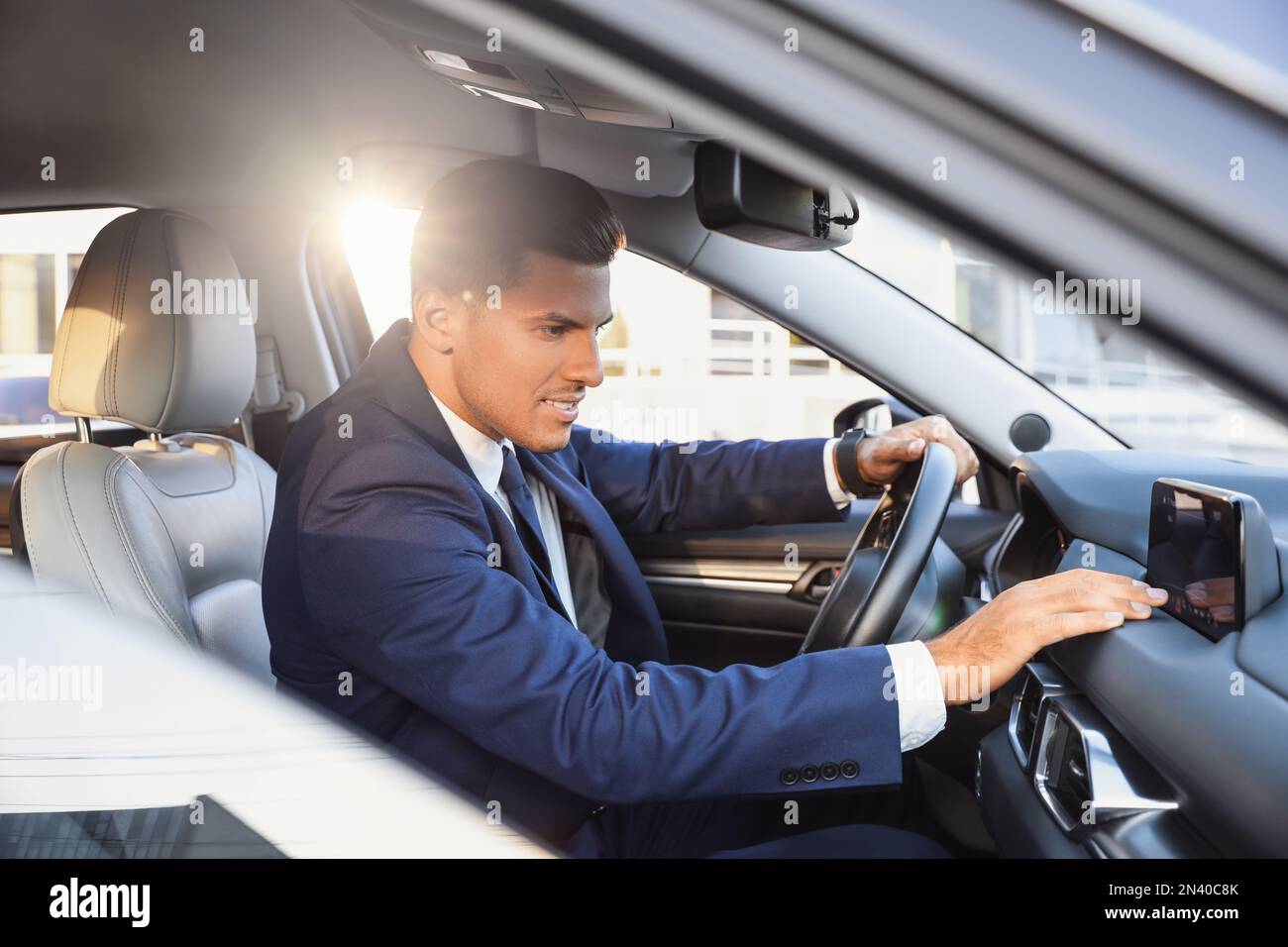 Handsome man driving his modern luxury car Stock Photo - Alamy