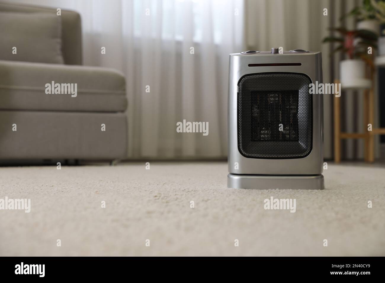 Modern electric infrared heater on floor in room interior. space for ...