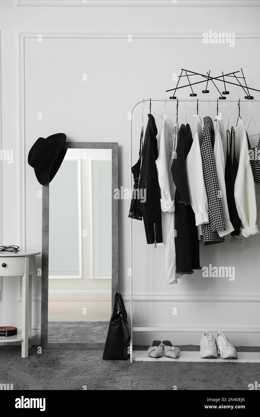 Rack with stylish clothes in modern dressing room Stock Photo - Alamy