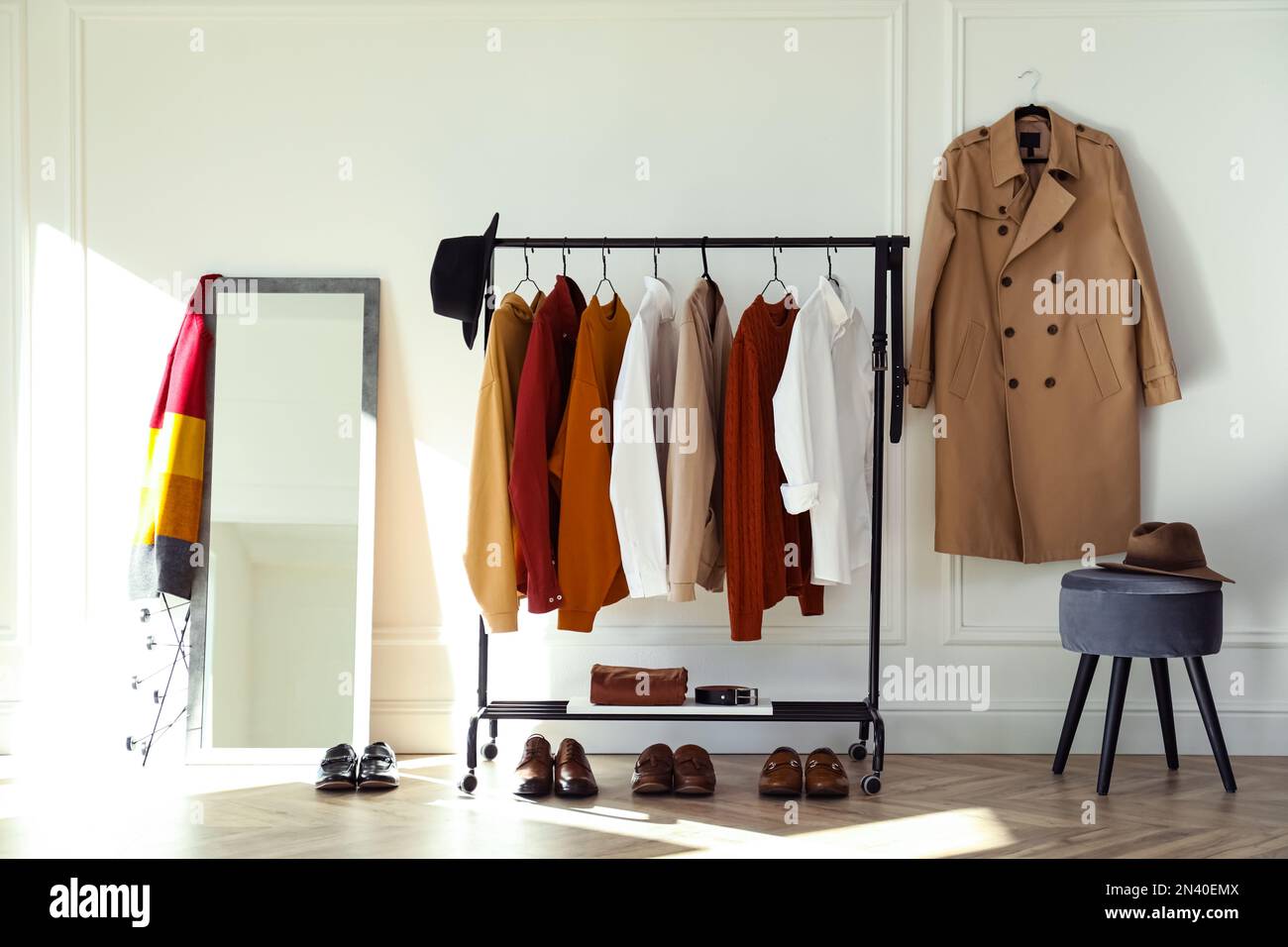 Rack with stylish clothes in modern dressing room Stock Photo - Alamy