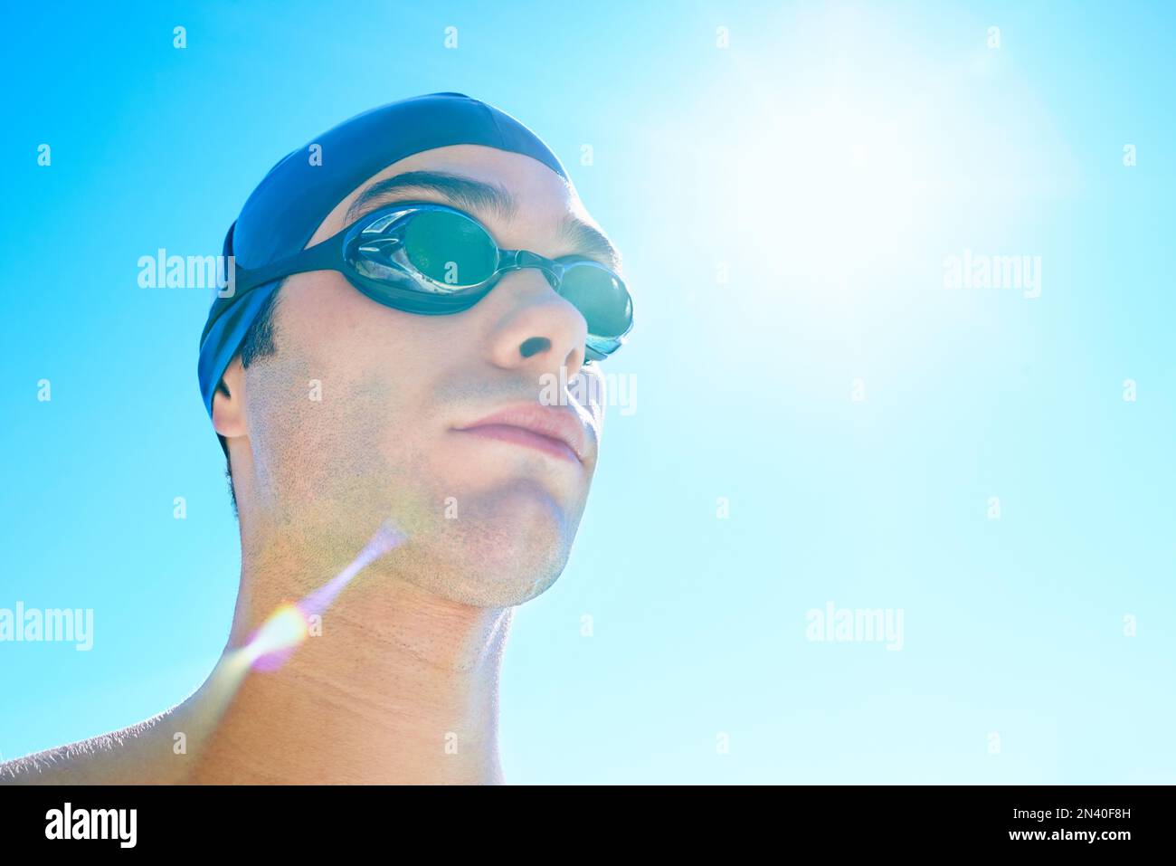 Winning is the only option. Cropped view of a male swimmer outdoors and ...