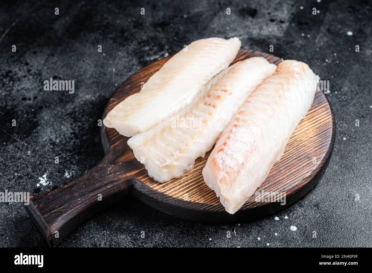 Fillets of codfish, raw cod fish meat. Black background. Top view Stock ...
