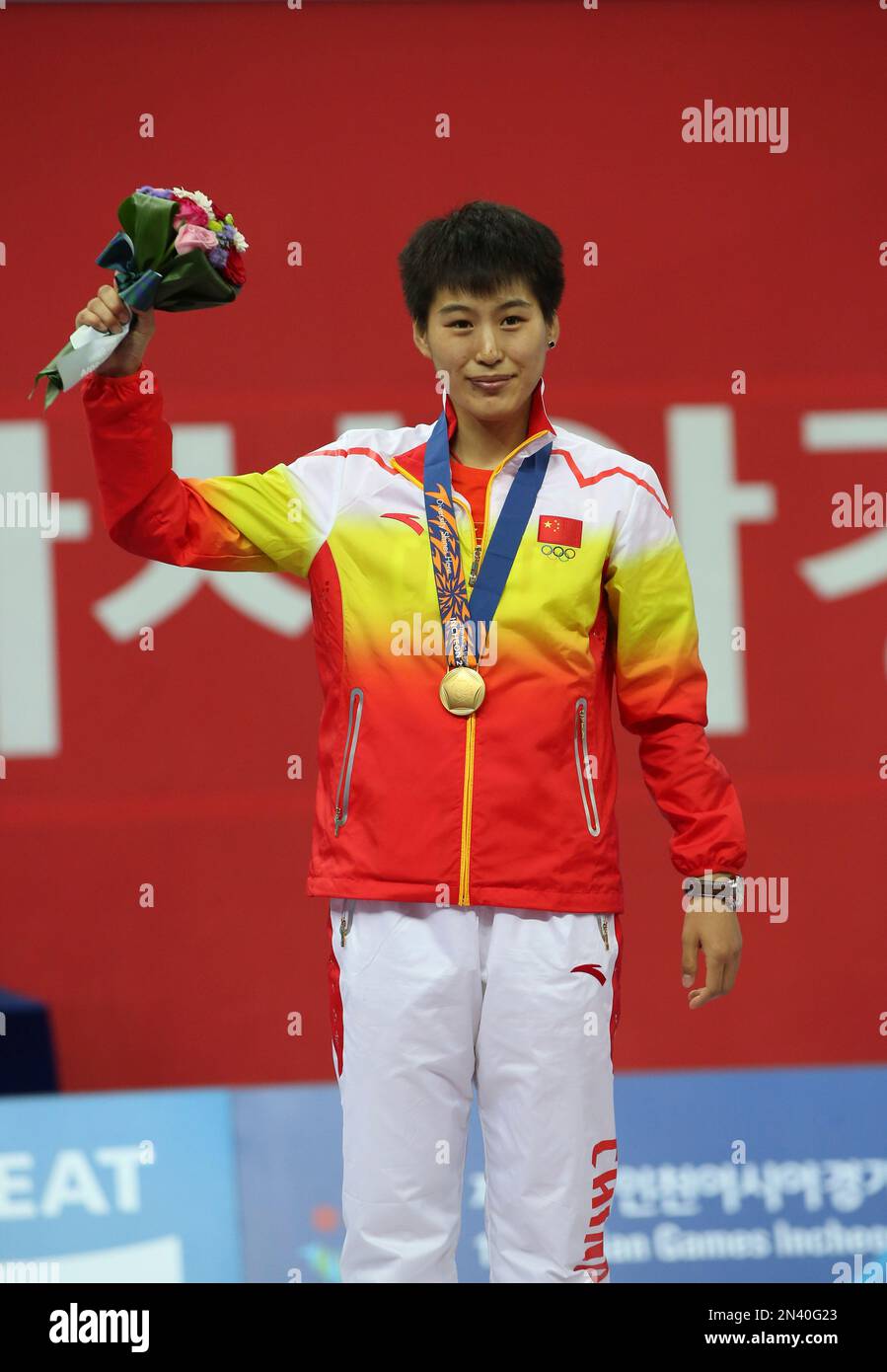 China's Wang Cong displays her gold medal she won in the women's 60kg ...