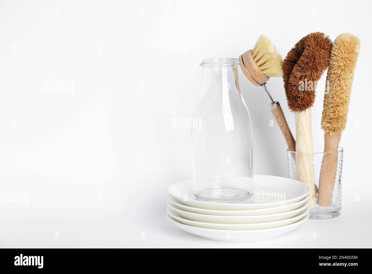 Cleaning brushes for dish washing, bottle and plates on white ...