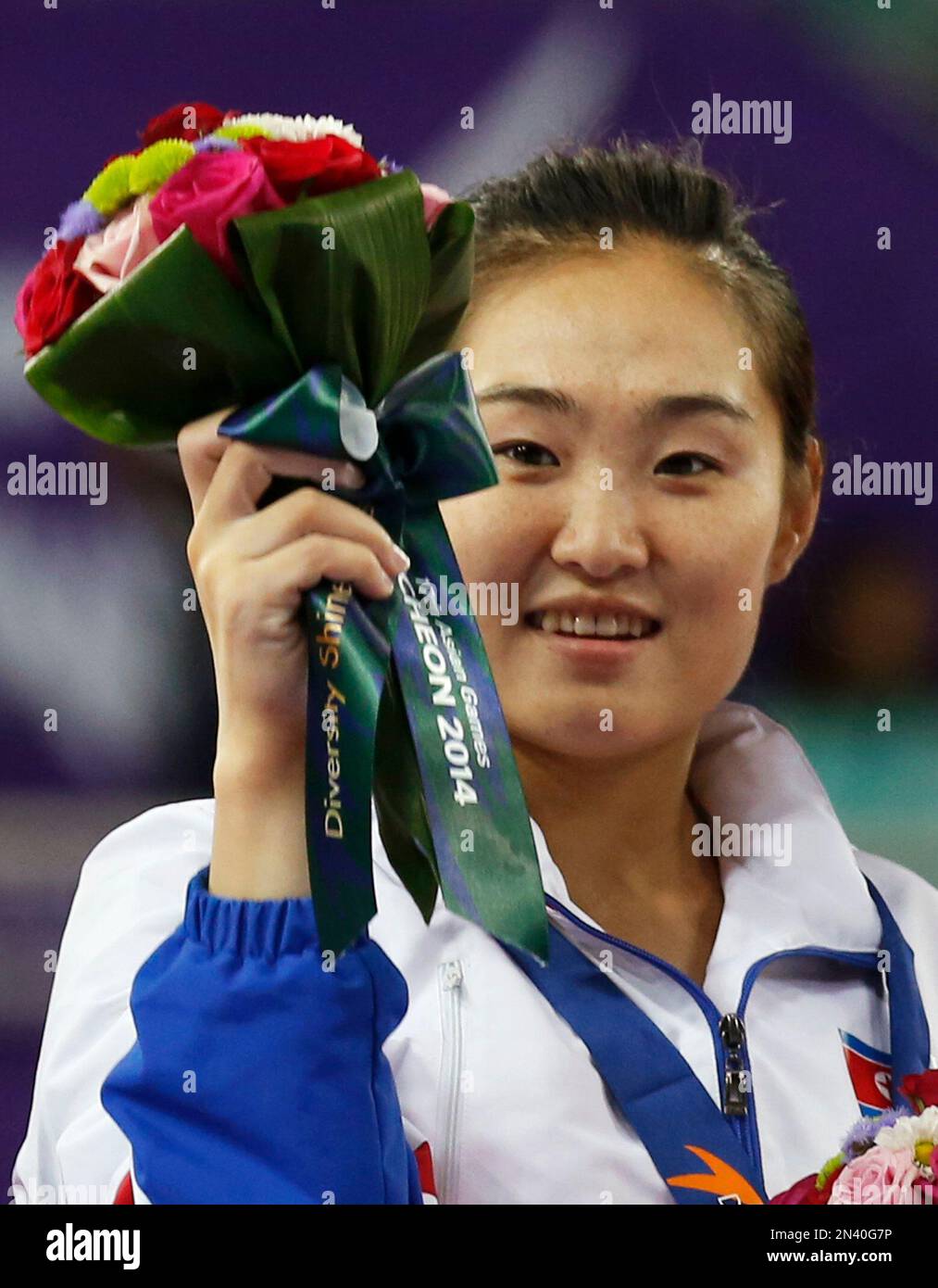 Gold medallist North Korea's Hong Un-jong raises her hand to ...