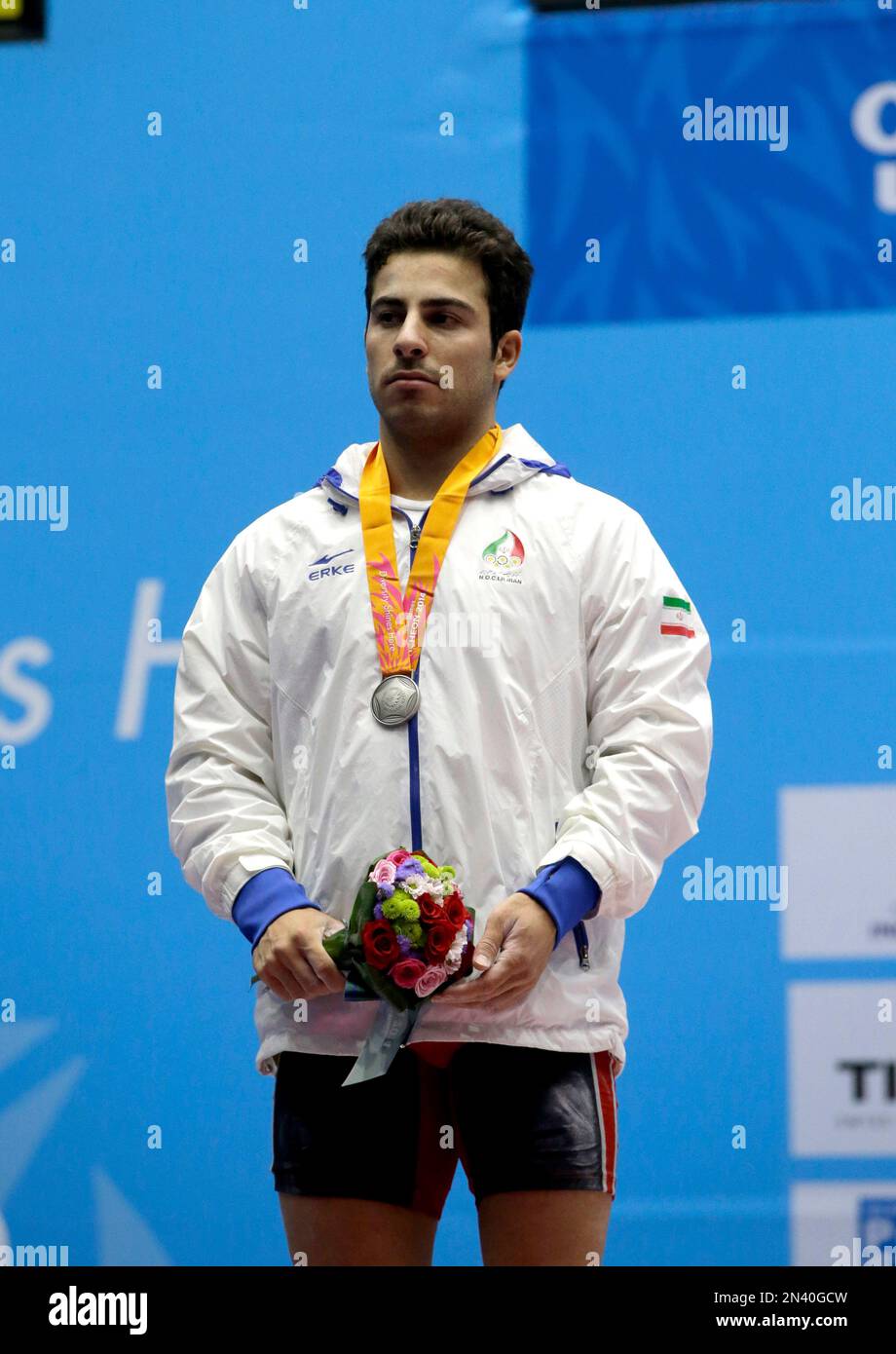Silver medalist Kianoush Rostami of Iran stands on the podium during ...