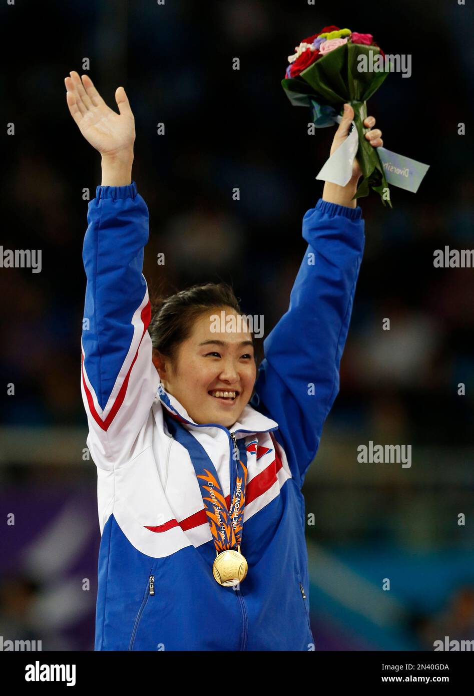 Gold medallist North Korea's Hong Un-jong raises her hands to ...
