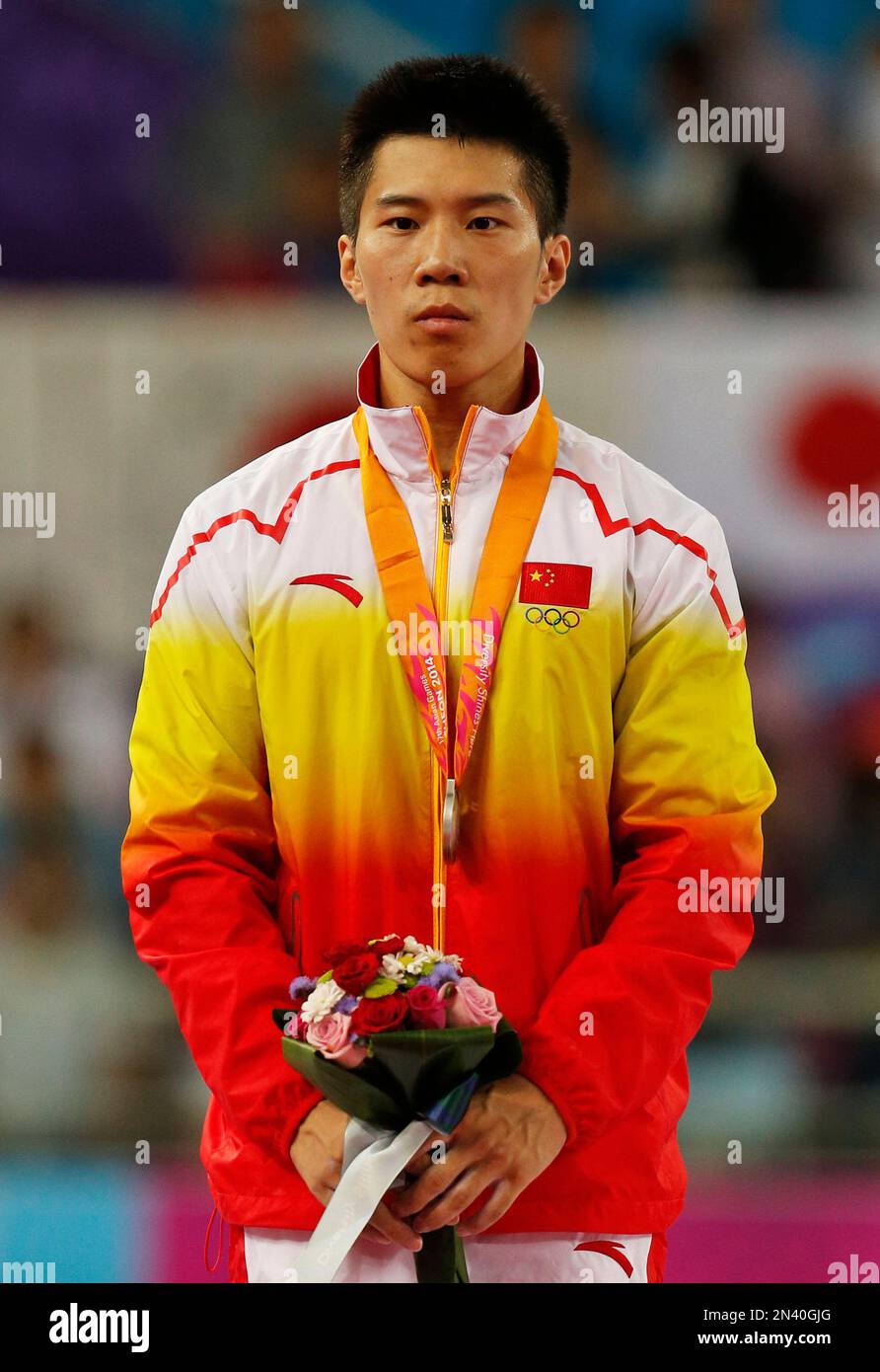 Silver medallist China's Huang Yuguo stands during the medal ceremony ...