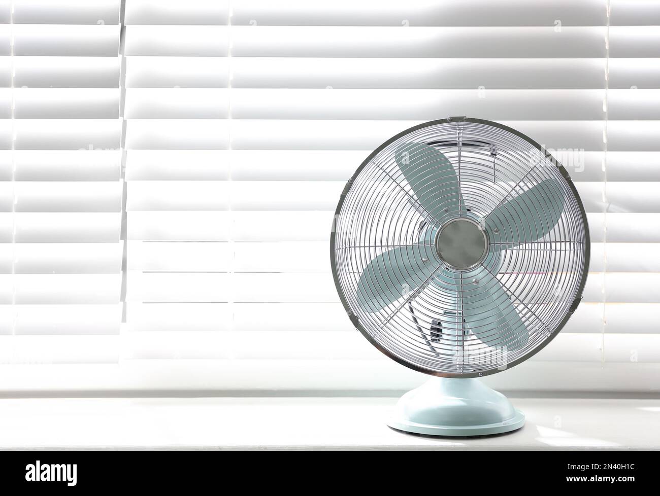 Modern electric fan on window sill indoors. Space for text Stock Photo ...