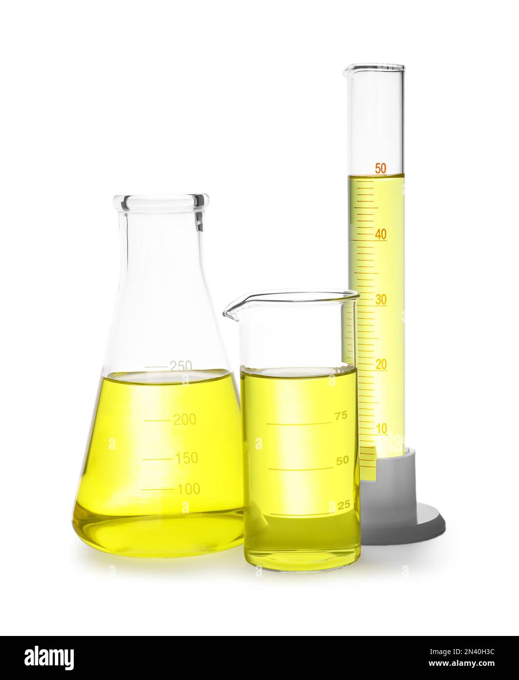 Different laboratory glassware with yellow liquid isolated on white ...