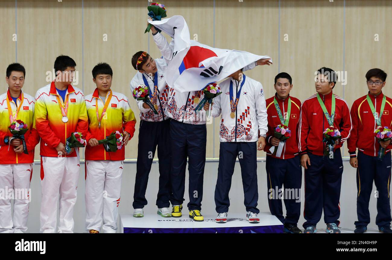 From left, silver medal winners China team, gold medal winners South Korea team and bronze medal ...