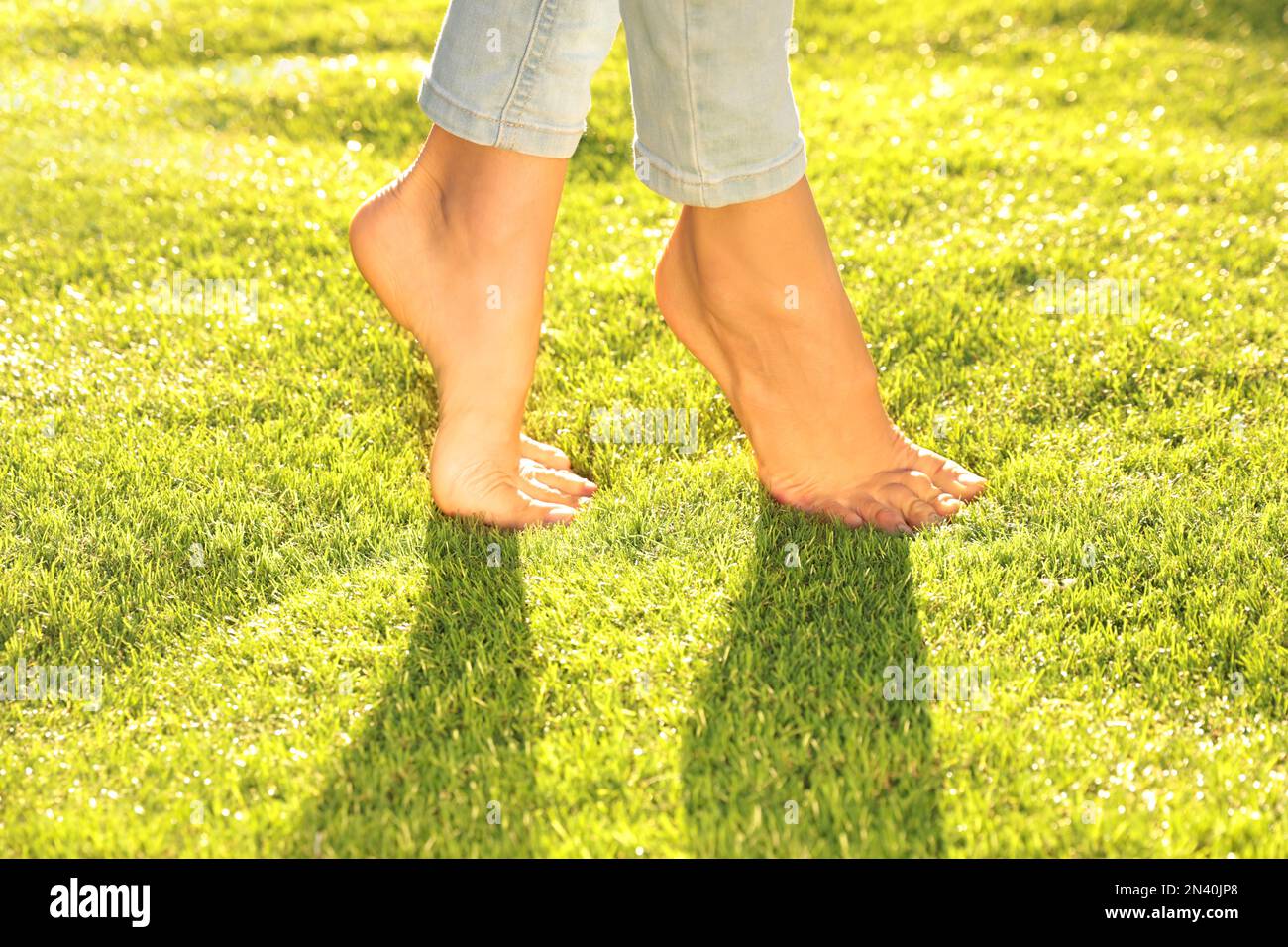 Woman walking barefoot on grass hi-res stock photography and images - Alamy