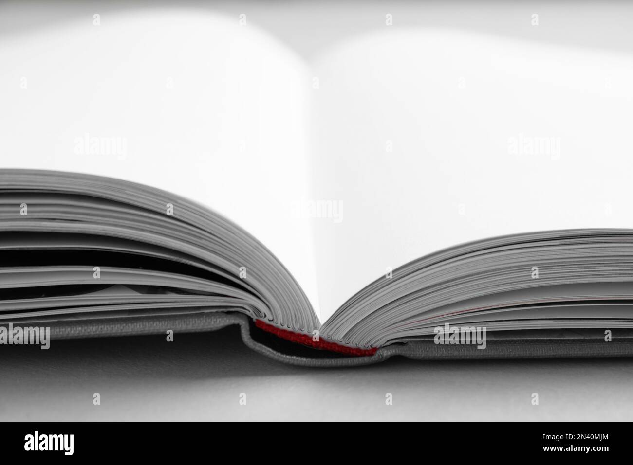 Open book with hard cover on light grey table, closeup Stock Photo - Alamy