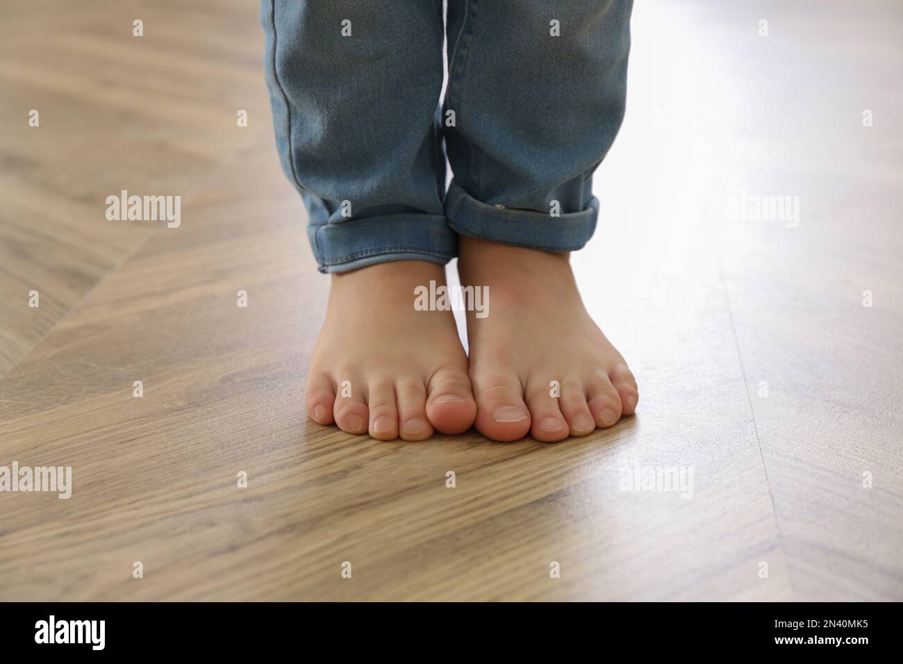 Little child walking barefoot at home, closeup. Floor heating concept ...