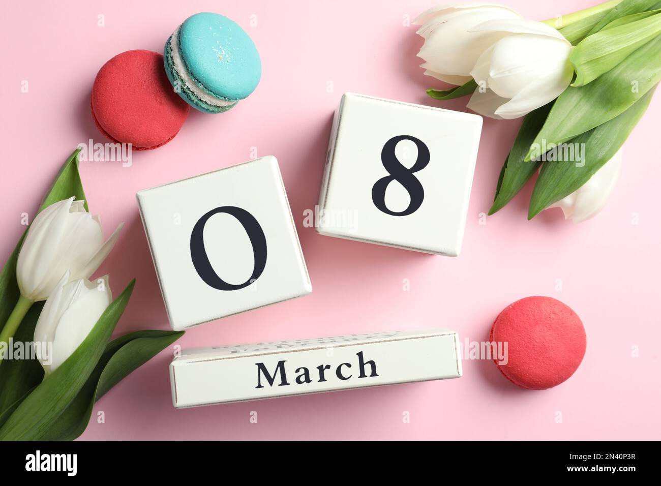 Wooden block calendar with date 8th of March, macarons and tulips on ...