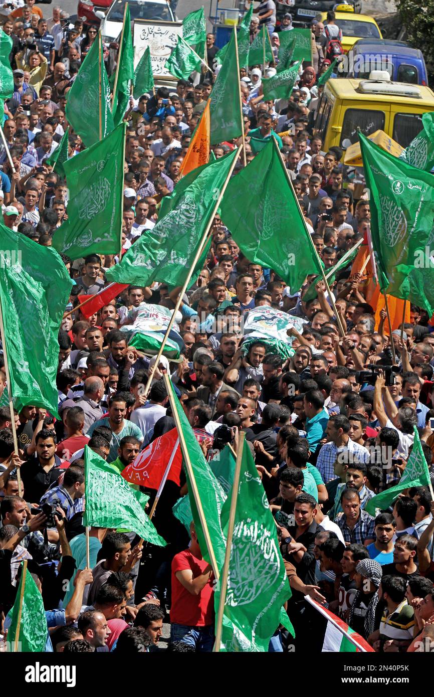 Mourners carry the bodies of Amer Abu Aisheh and Marwan Qawasmeh who ...