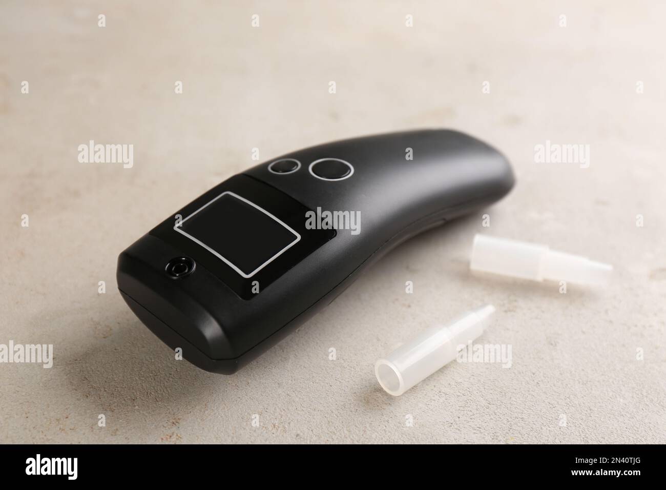 Modern breathalyzer with mouthpieces on light grey stone table Stock ...