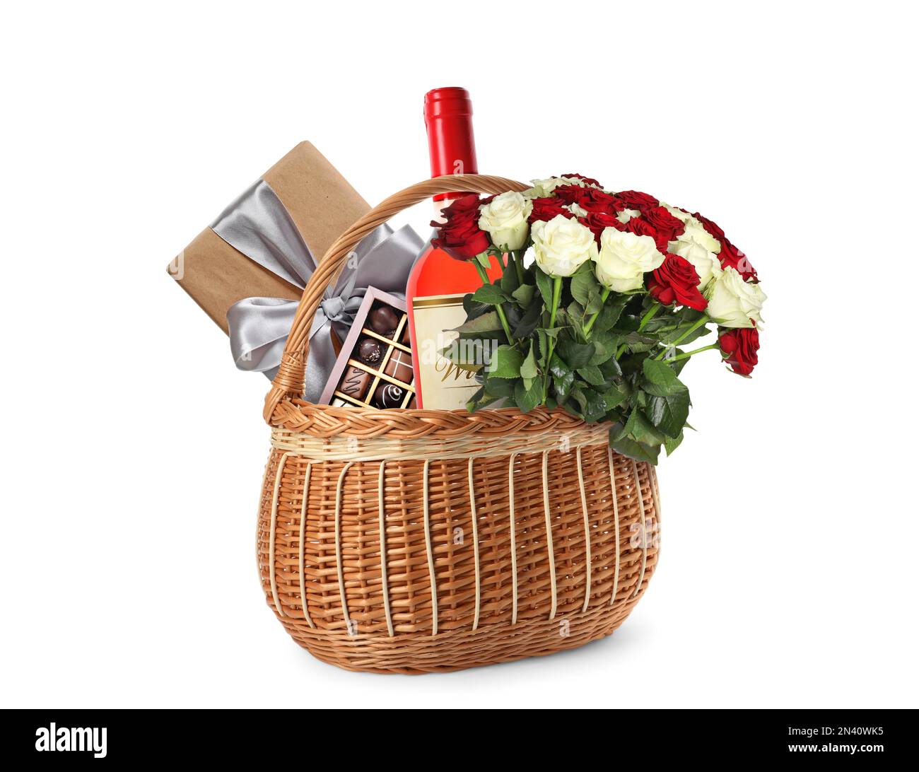 Wicker basket with gifts on white background Stock Photo - Alamy