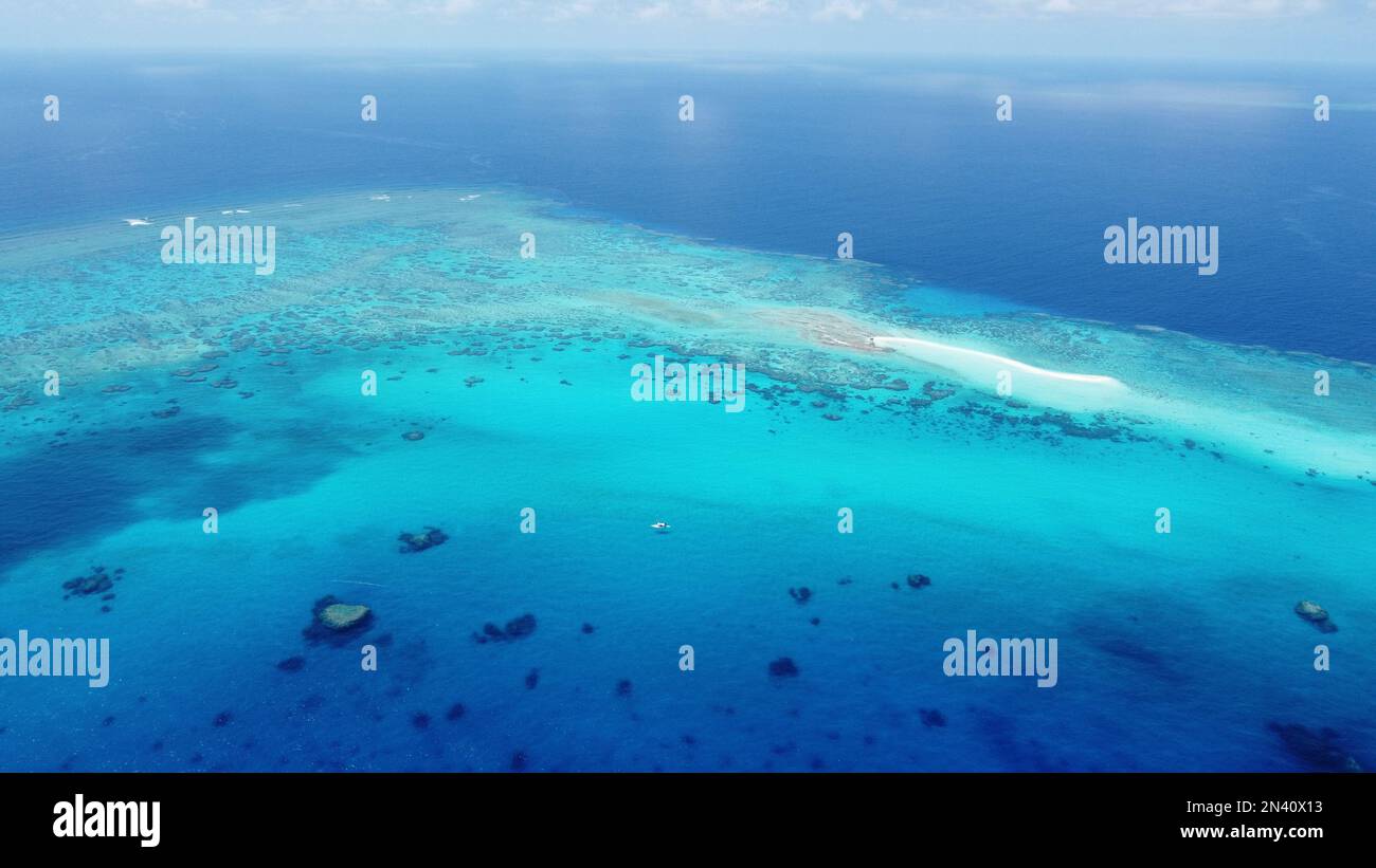 Small sand cay with a remote weather station on surrounded by fringing ...