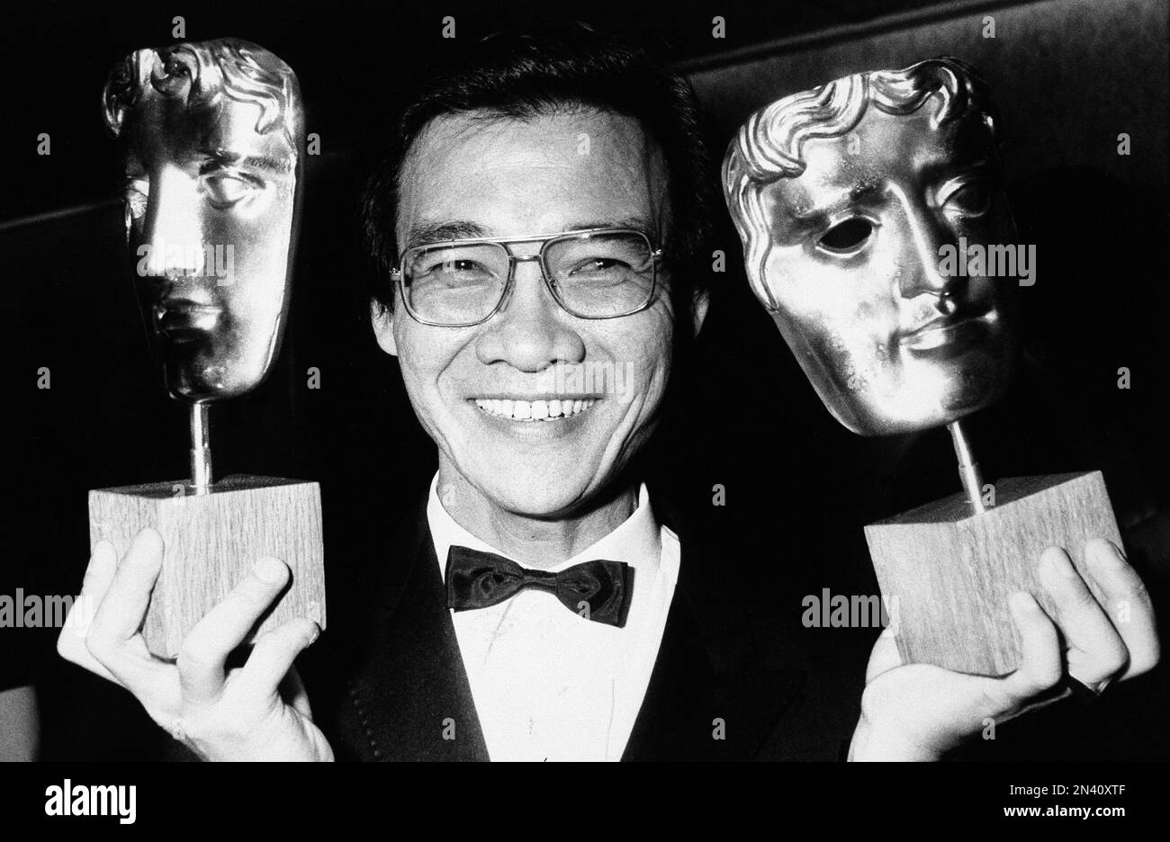 Cambodian actor Haing S. Ngor holds two awards in this undated photo ...