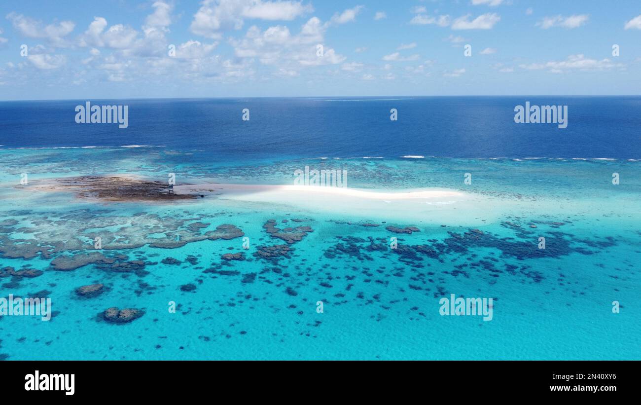 Small sand cay with a remote weather station on surrounded by fringing ...