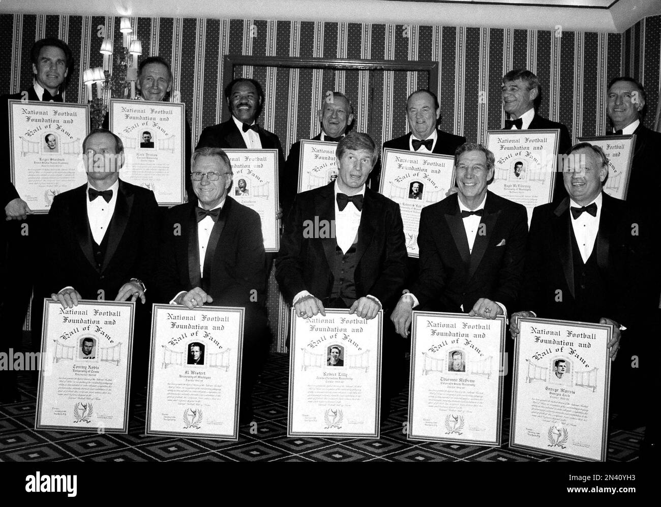 Inductees into the College Football Hall of Fame pose with their ...