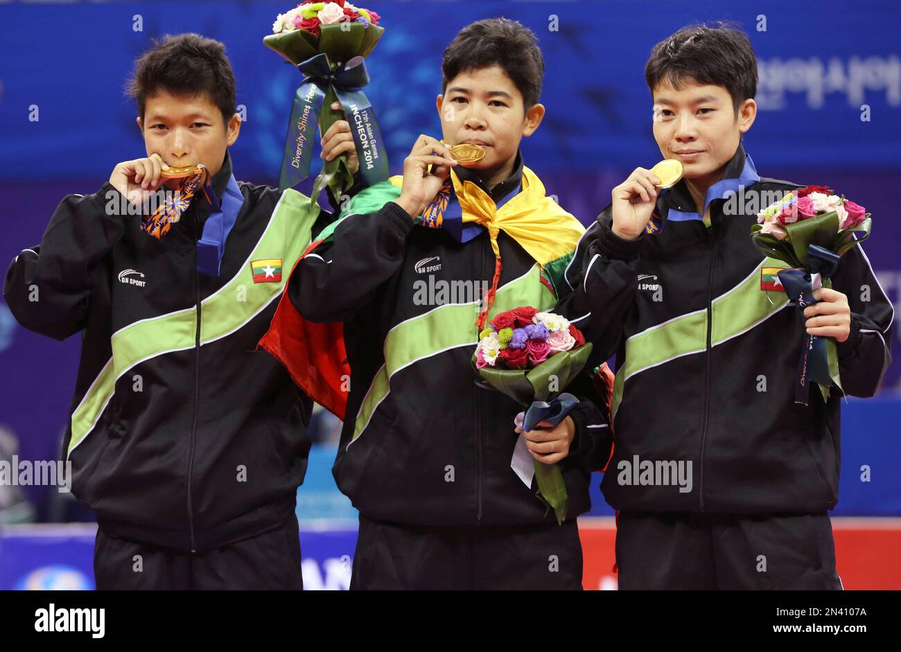 Myanmar's gold medalists Kyu Kyu Thin, center, Khin Hnin Wai, right ...