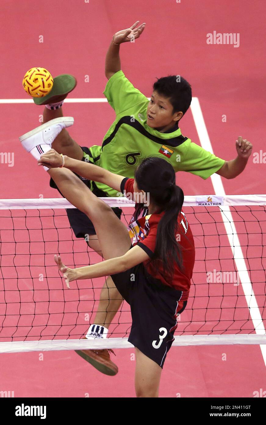 Myanmar's Phyu Phyu Than, top, kicks a ball as Laos's Koy Xayavong ...
