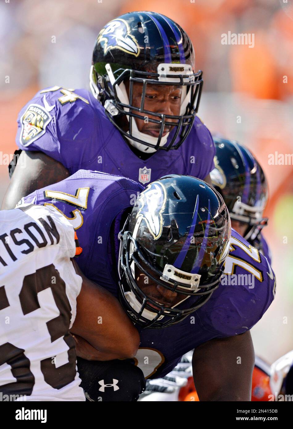 Baltimore Ravens running back Lorenzo Taliaferro, top, pushes through ...