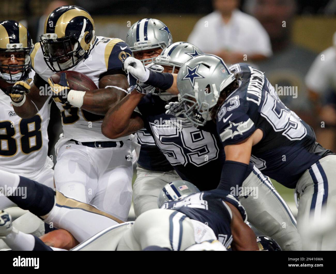 St. Louis Rams running back Zac Stacy, left, struggles for yardage ...
