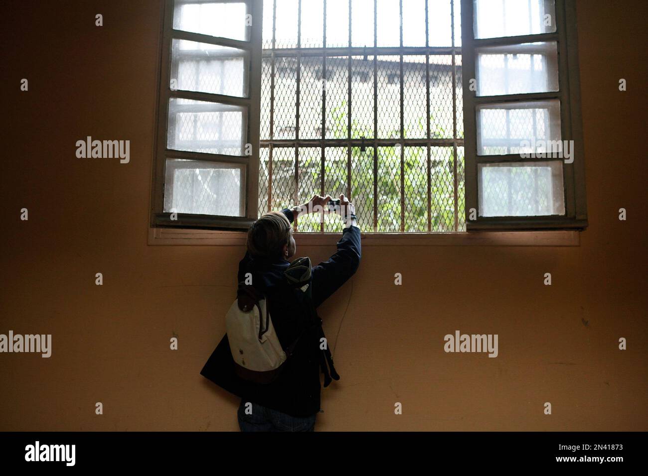 A woman takes a snapshot as she visits La Sante prison, in Paris ...