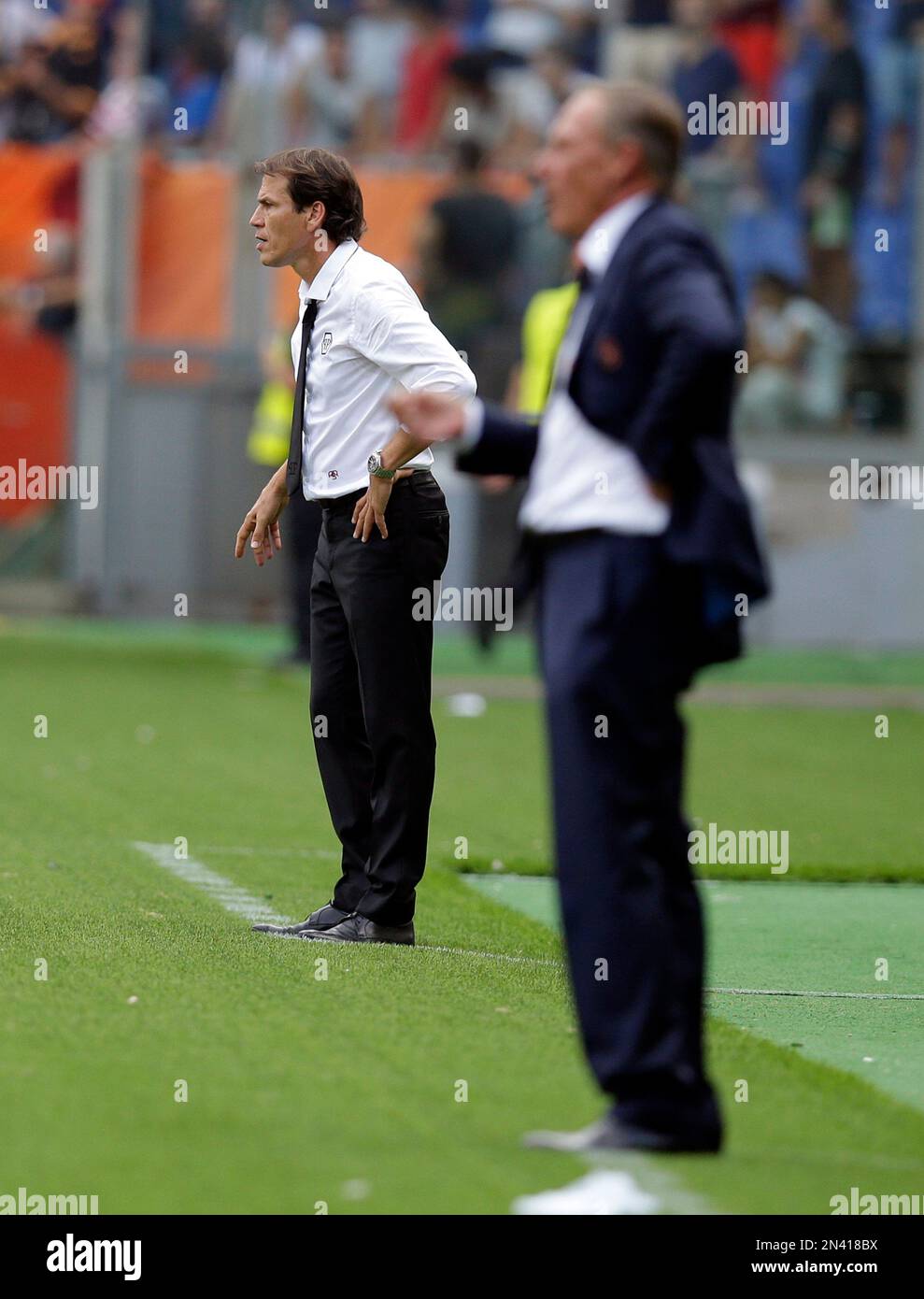 Roma coach Rudy Garcia, left, and Cagliari coach Zdenek Zeman follow a ...