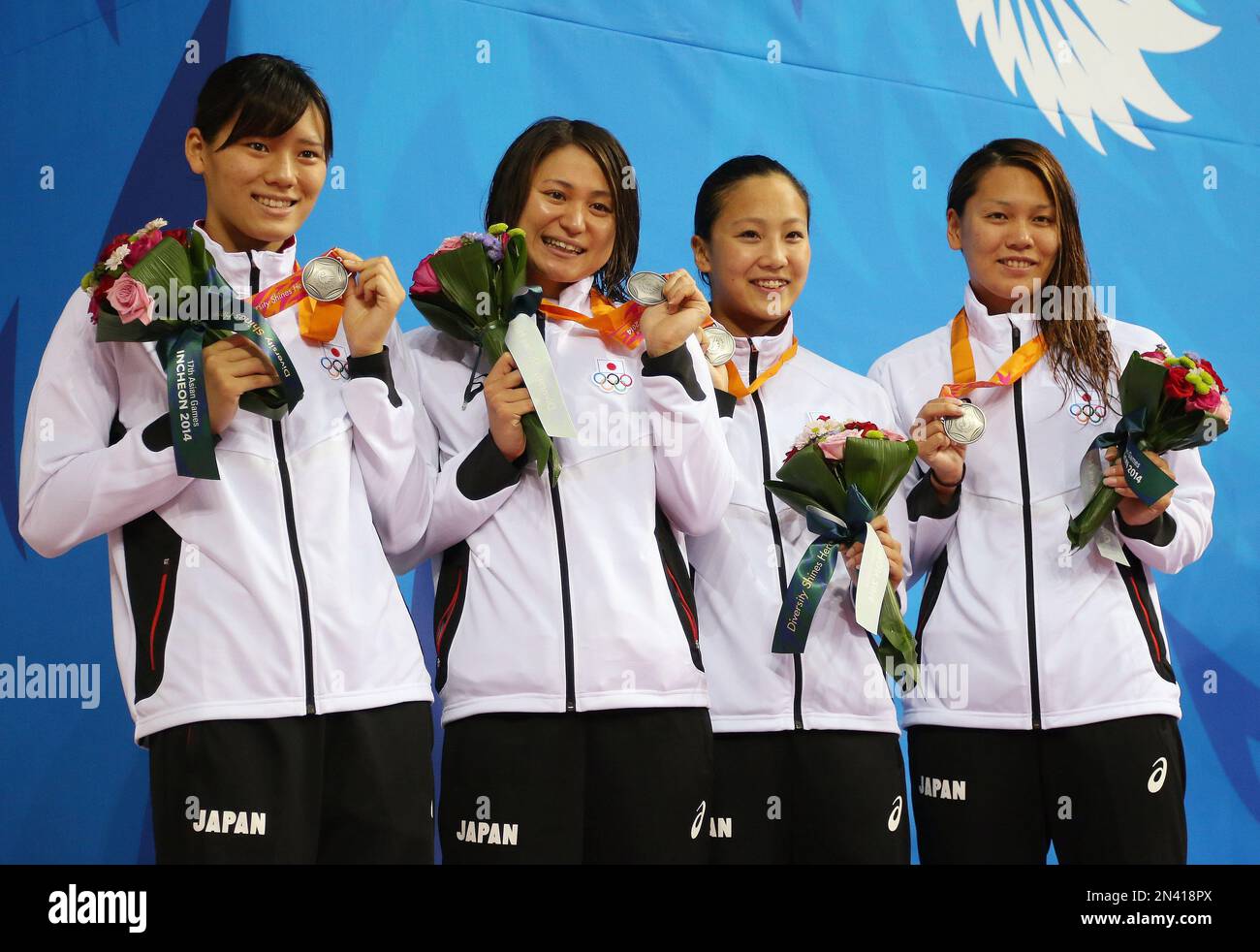 Members of the Japanese women's 4x100 meters freestyle relay team pose ...